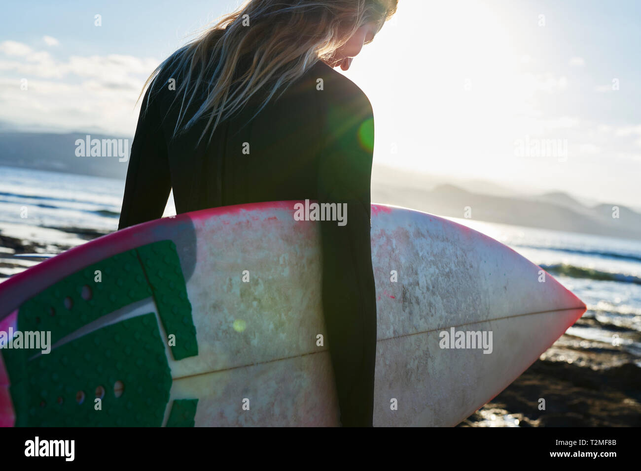 Surfer with surfboard on beach Stock Photo - Alamy