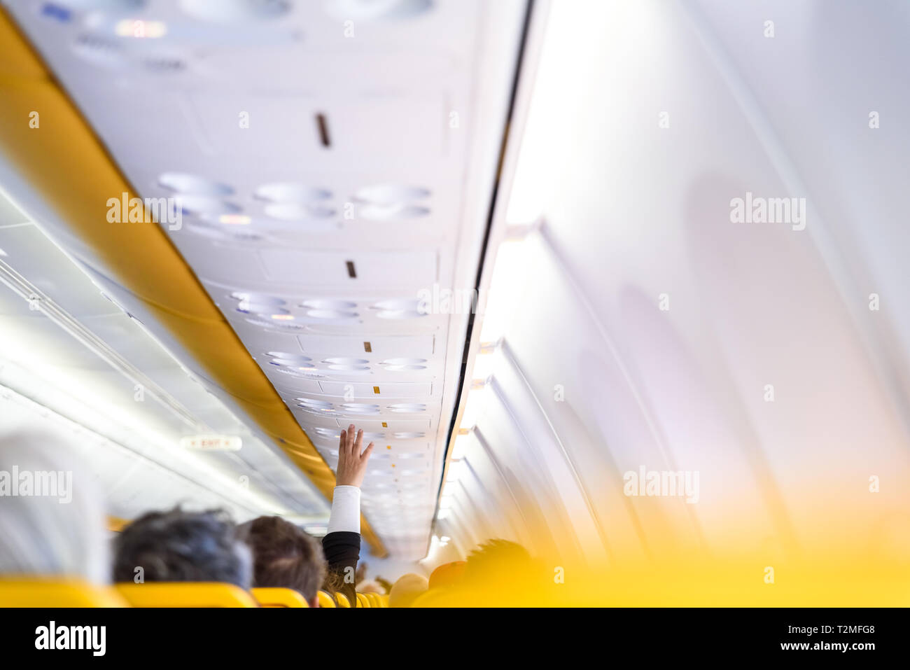 Business passenger on a plane requesting assistance from stewardesses ...
