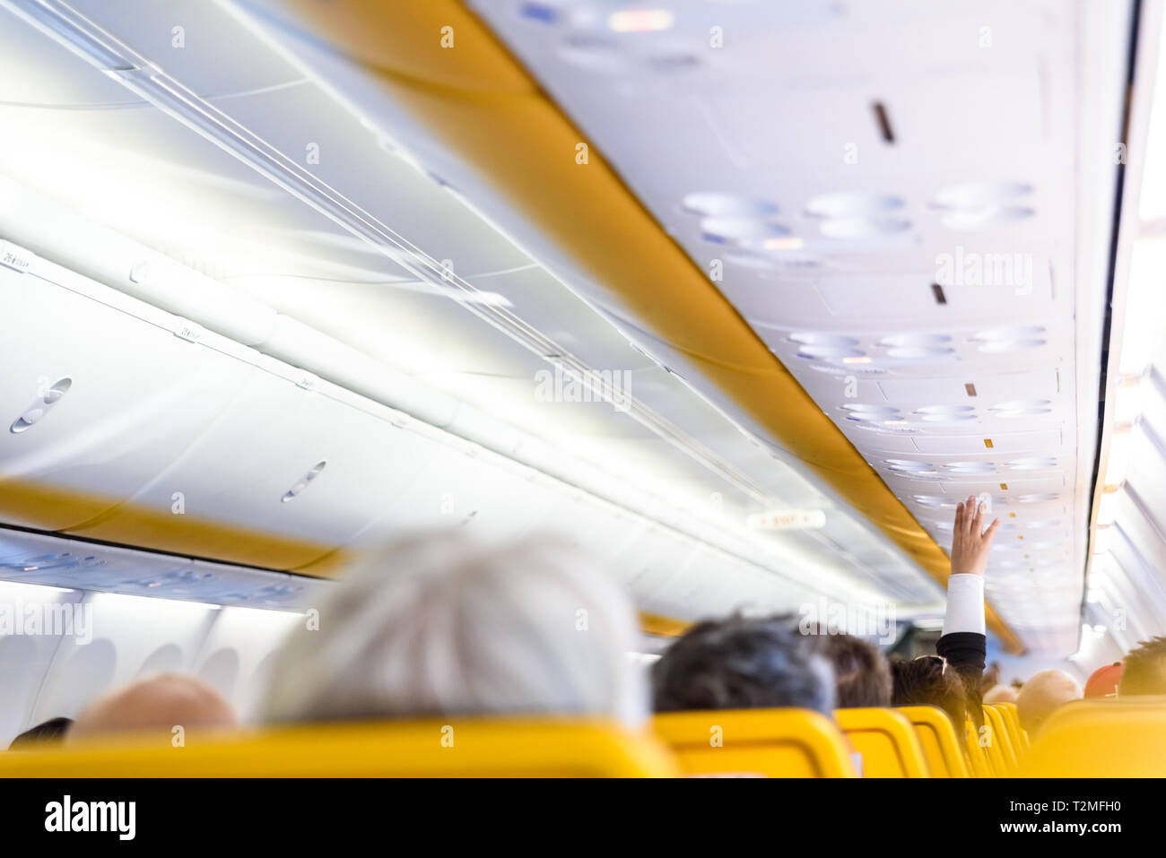 Business passenger on a plane requesting assistance from stewardesses ...