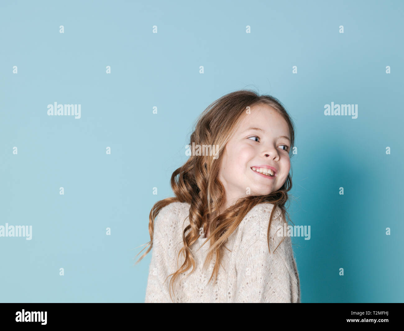 pretty and cool 9 year old girl with brown wool sweater posing in front ...