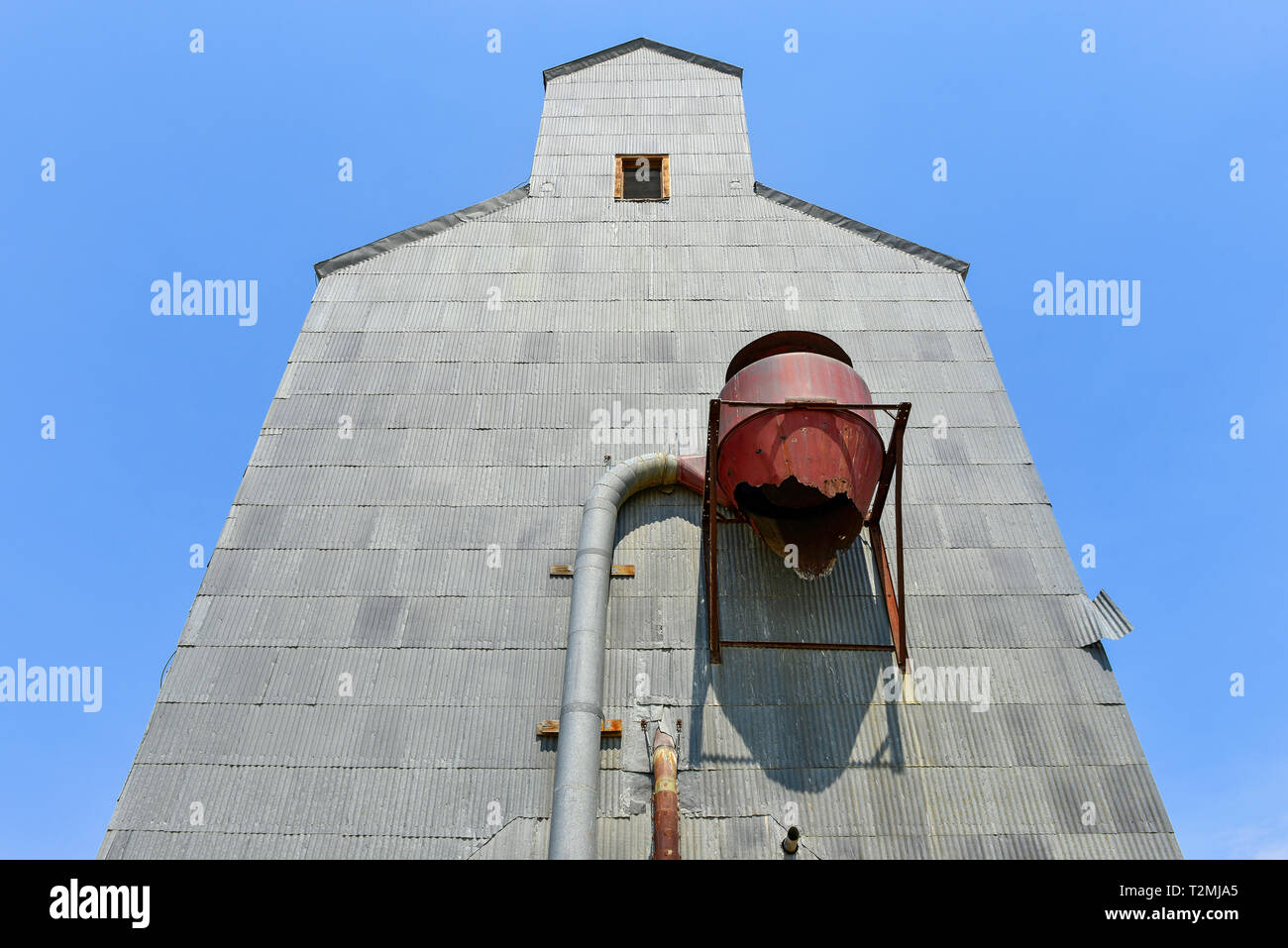Metal grain elevator with rusted chute upward Stock Photo - Alamy