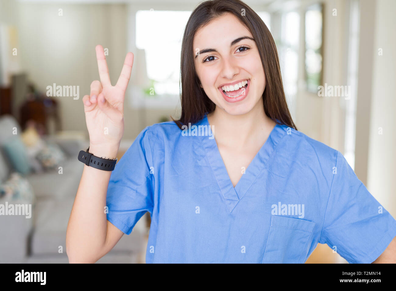 Beautiful young nurse woman at the clinic smiling with happy face ...