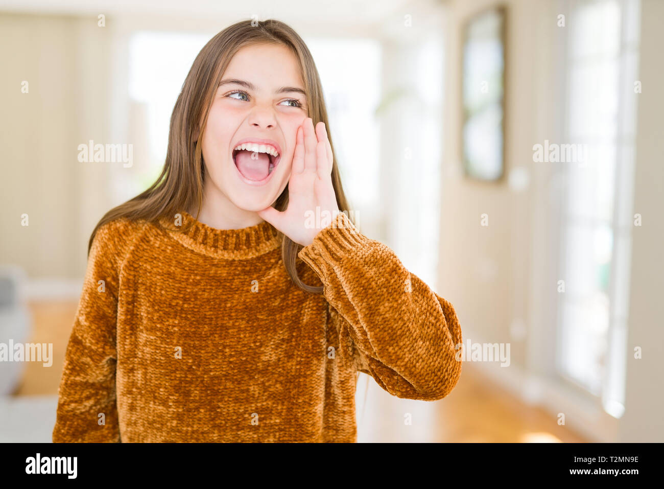 Beautiful young girl kid at home shouting and screaming loud to side ...