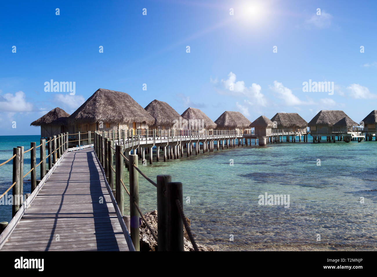 Authentic houses with a straw roof over water of the blue sea and the ...
