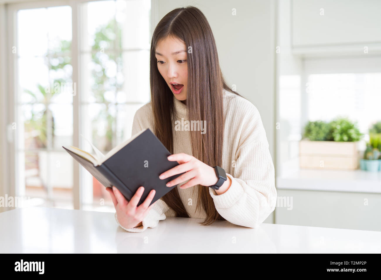 Woman shock reading book library hi-res stock photography and images ...