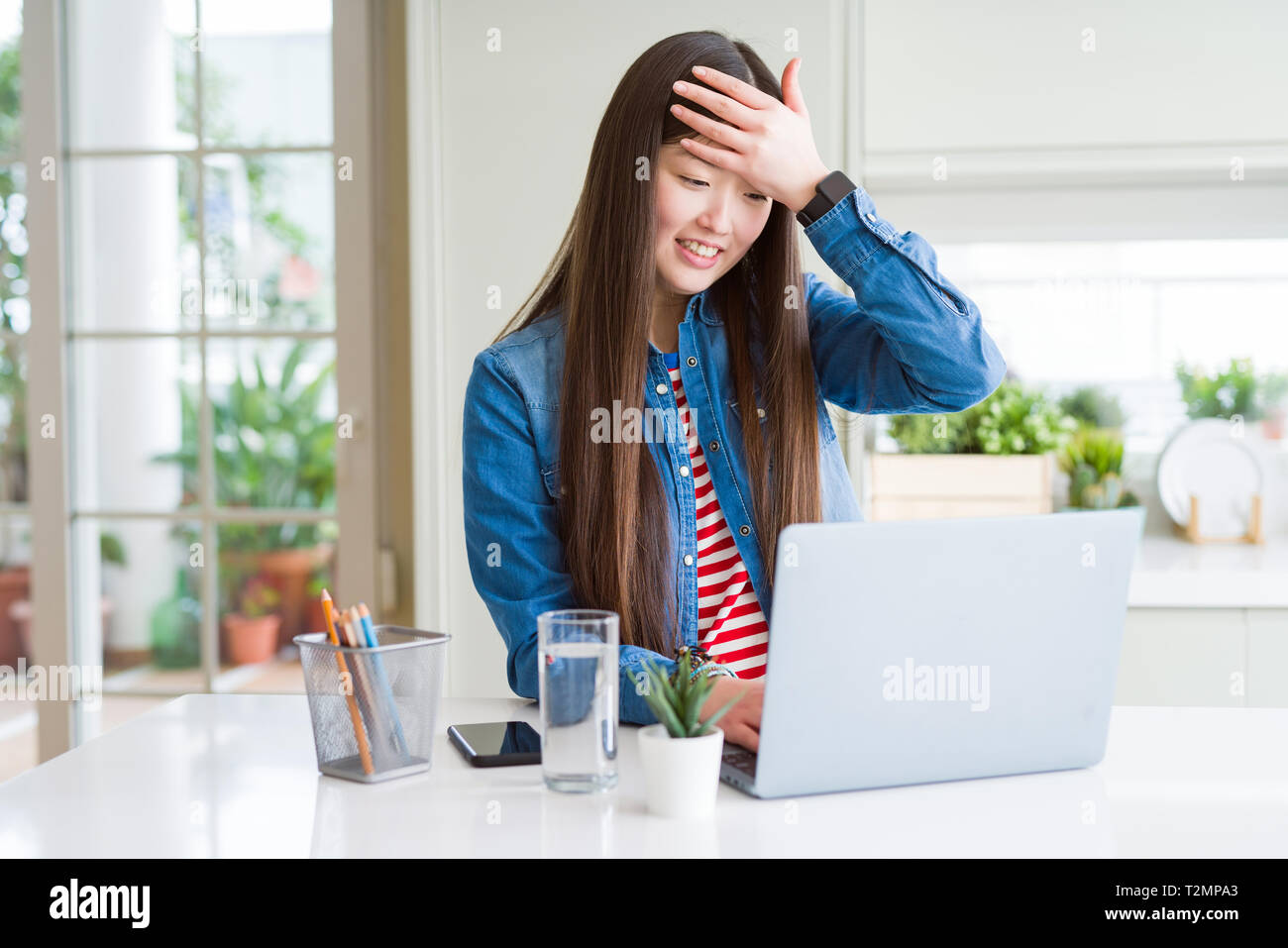 Beautiful Asian woman working using computer laptop stressed with hand ...
