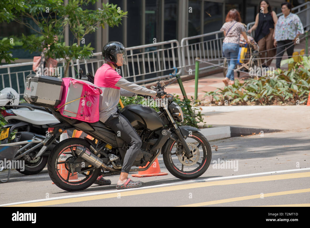 Delivery service workers in motorcycle hi-res stock photography and ...