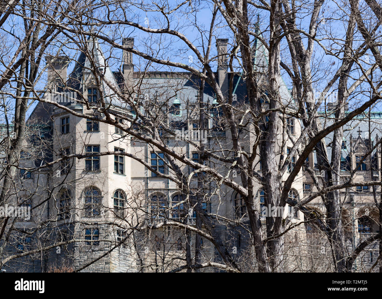 The rear view of the Biltmore House can be seen from a trail through ...