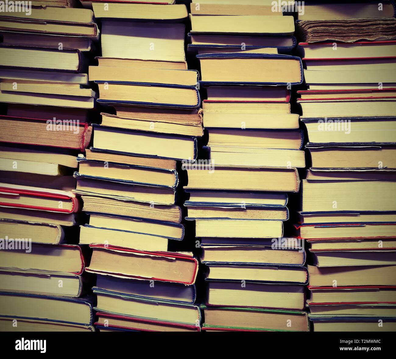 background of many book with vintage old toned effect in the library ...