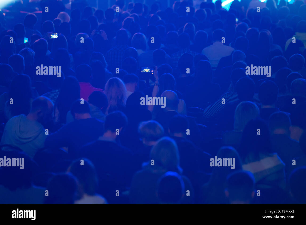 Audience listens to the lecturer at the business conference, back view ...