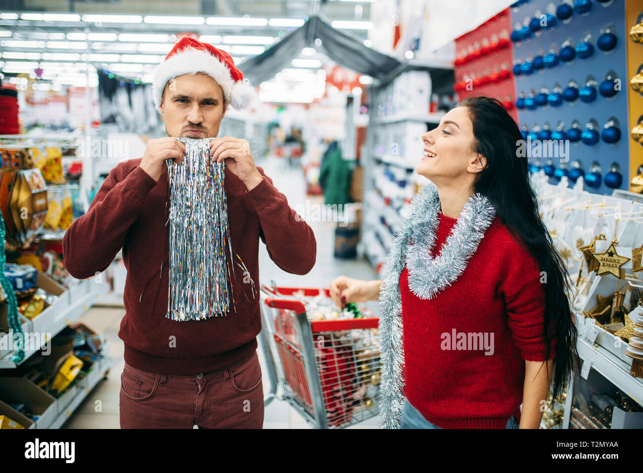 Couple buying christmas decorations at christmas market hi-res stock ...