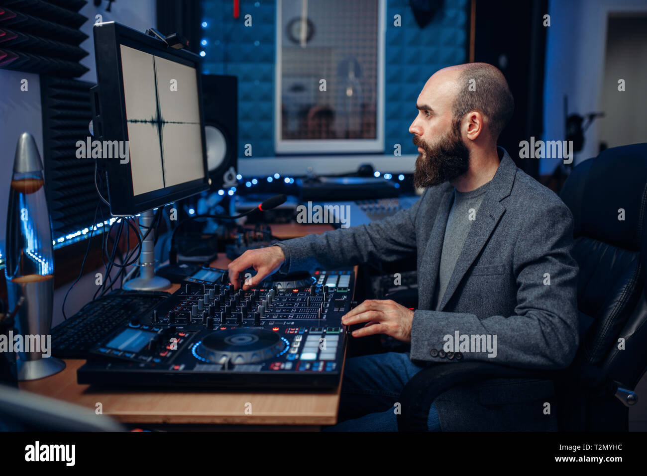 Sound engineer working at the remote control panel in the recording ...