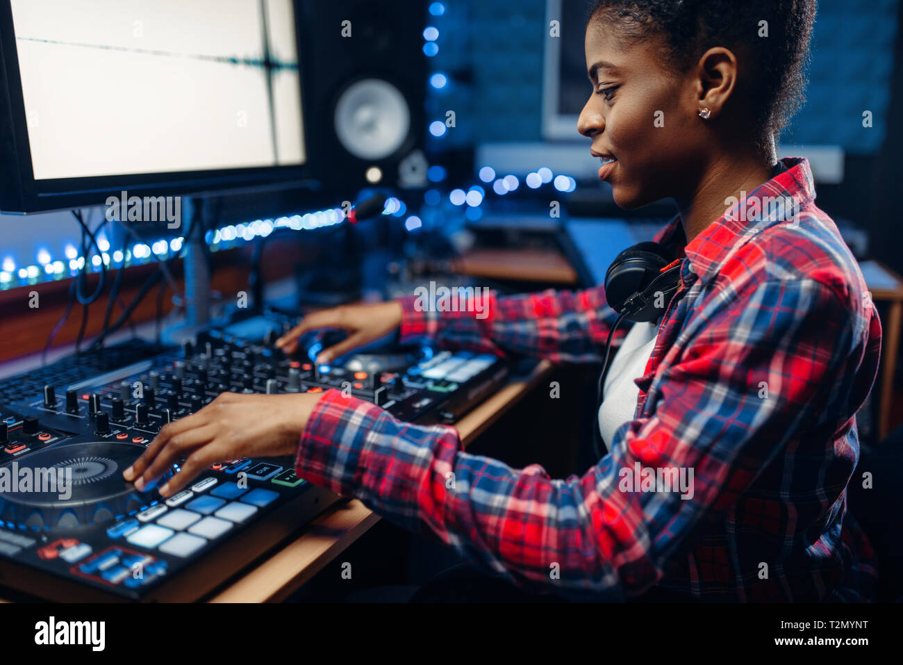 Female sound engineer working at the remote control panel in the ...