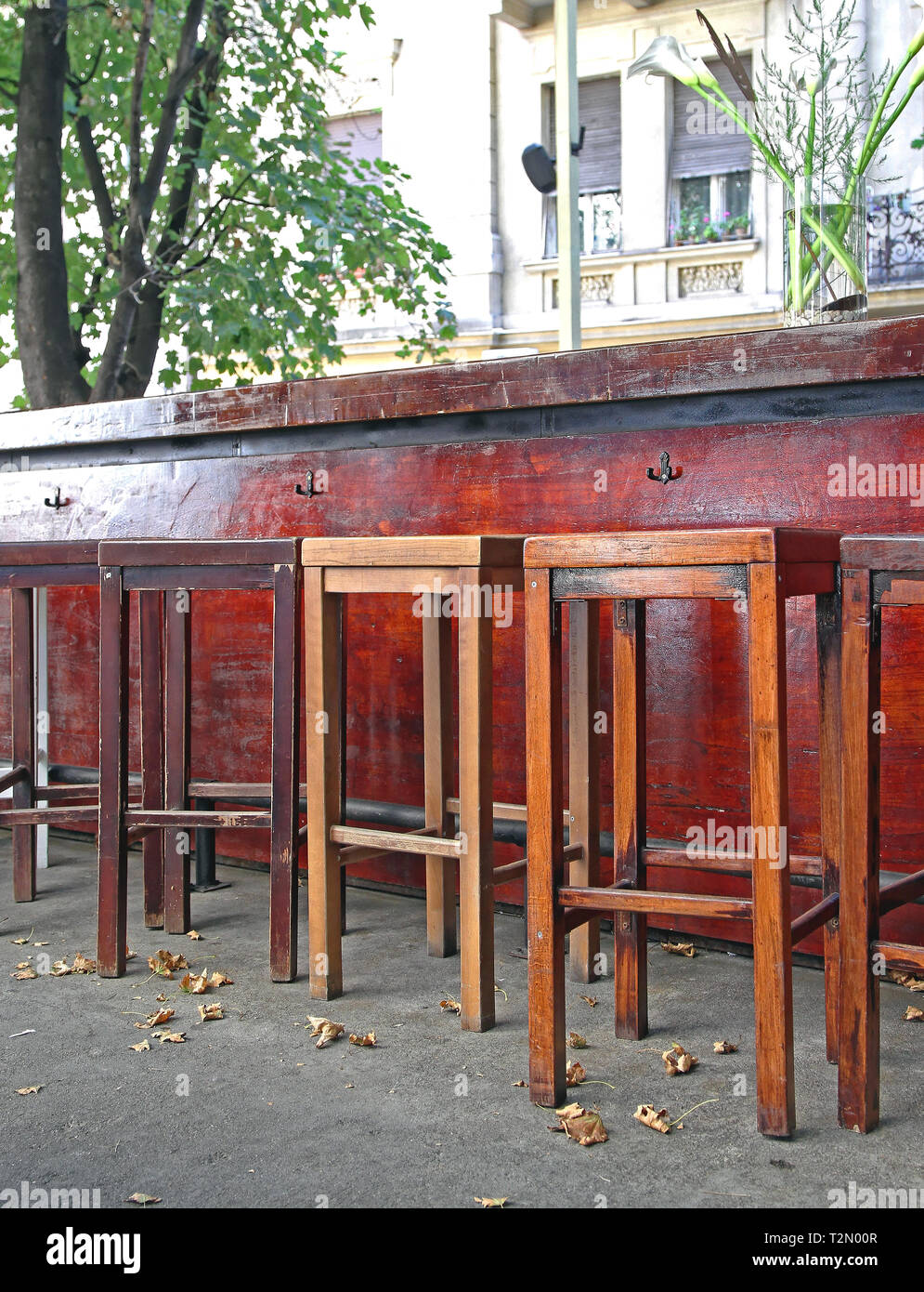 Wooden Stool Chairs at Red Wood Bar Counter Outdoor Stock Photo - Alamy