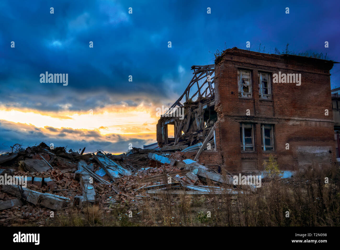 The ruins of a destroyed building in the city against the backdrop of a ...