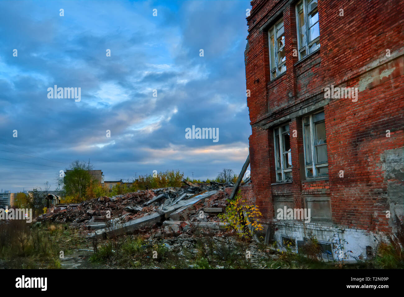 The ruins of a destroyed building in the city against the backdrop of a ...
