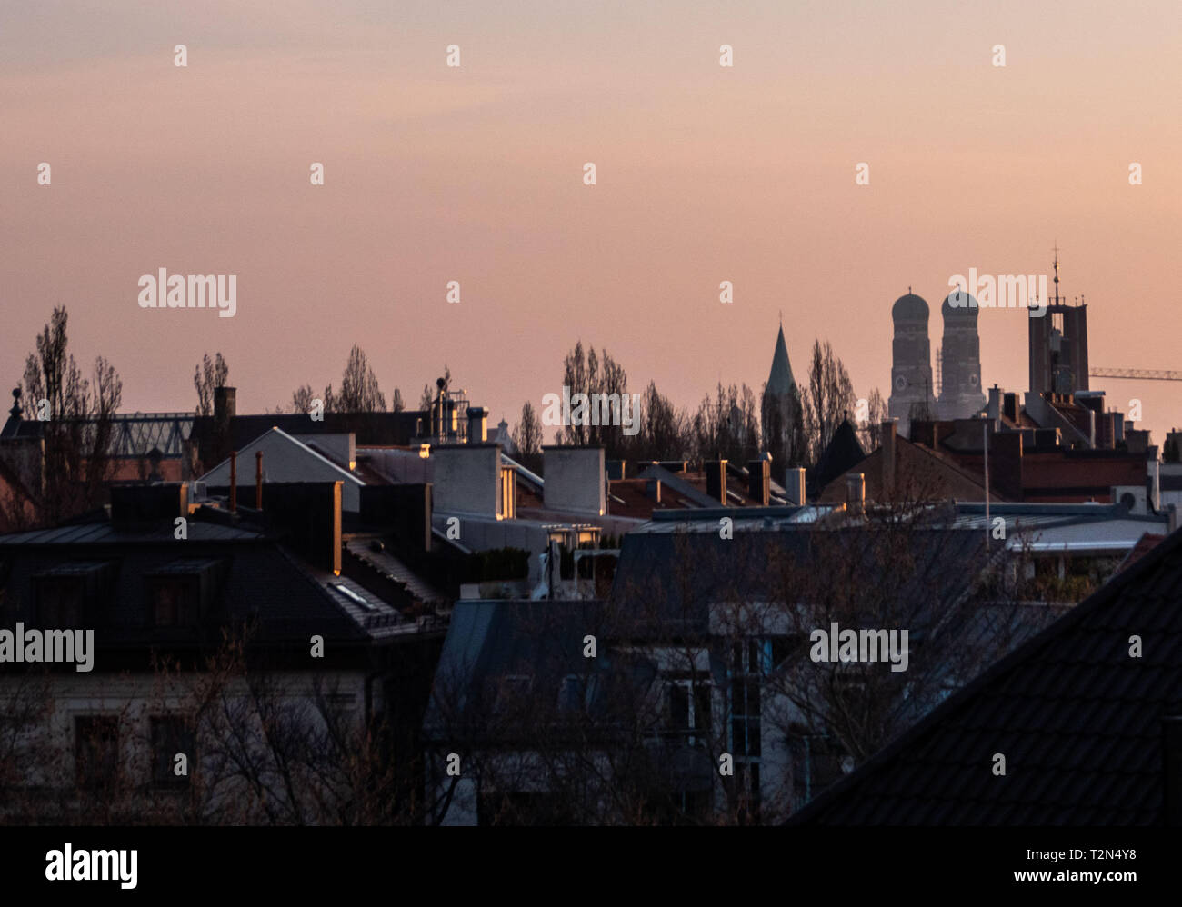 02 April 2019, Bavaria, München: The Munich Frauenkirche in the dawn ...