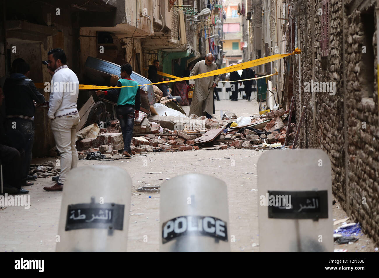 Cairo, Egypt. 3rd Apr, 2019. People walk by the site where a building ...