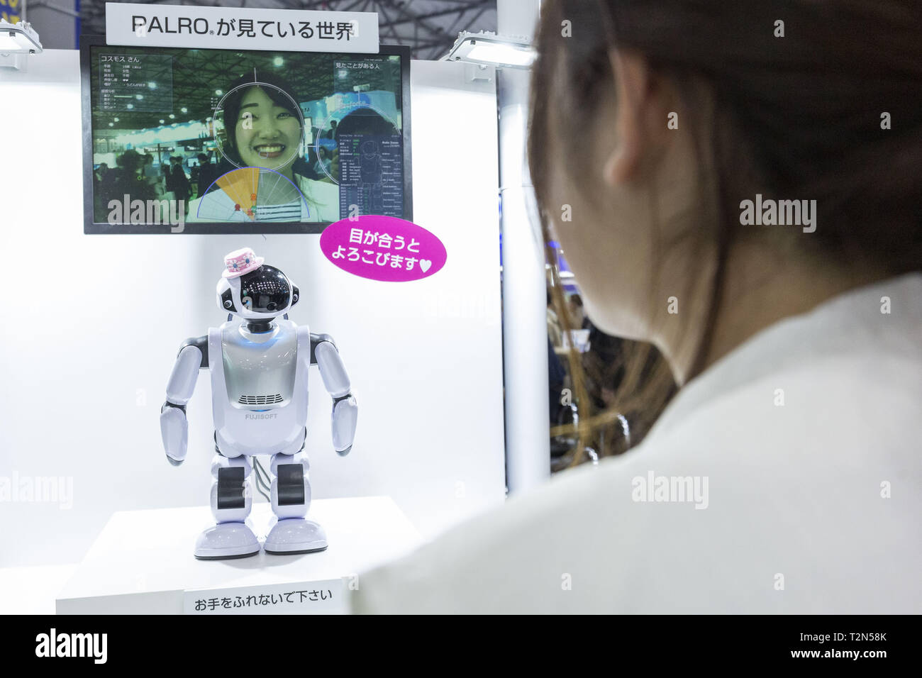 Tokyo, Japan. 3rd Apr, 2019. A display shows a woman's face through ...