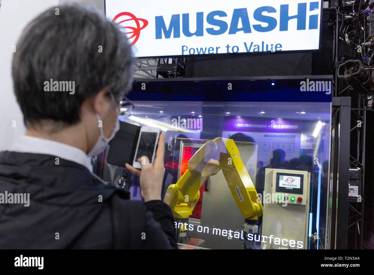 Tokyo, Japan. 03rd Apr, 2019. A man takes pictures of AI technology ...