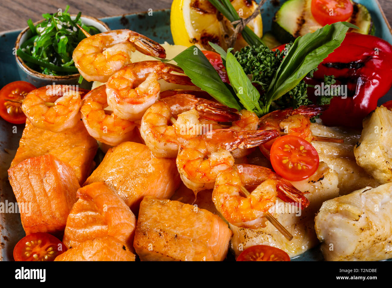 Fish and prawn plate served grilled vegetables Stock Photo - Alamy