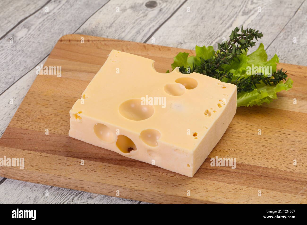 Maasdam cheese brick with thyme branch Stock Photo - Alamy
