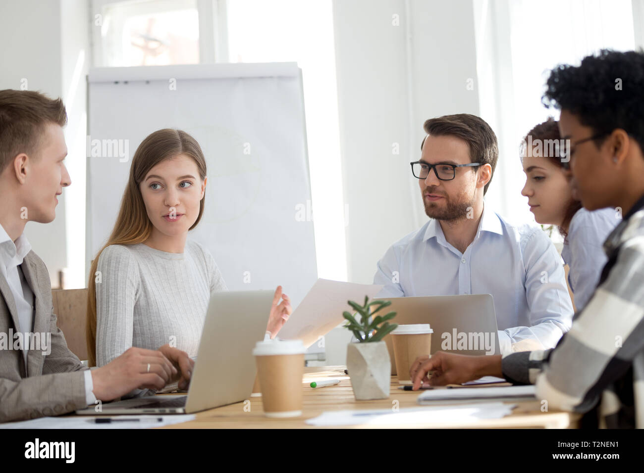 Five diverse multiracial business people colleagues working using ...