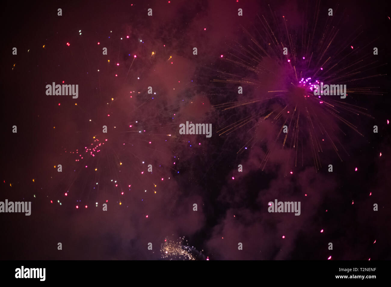 Explosive and colorful holiday fireworks at night sky. Celebration City ...