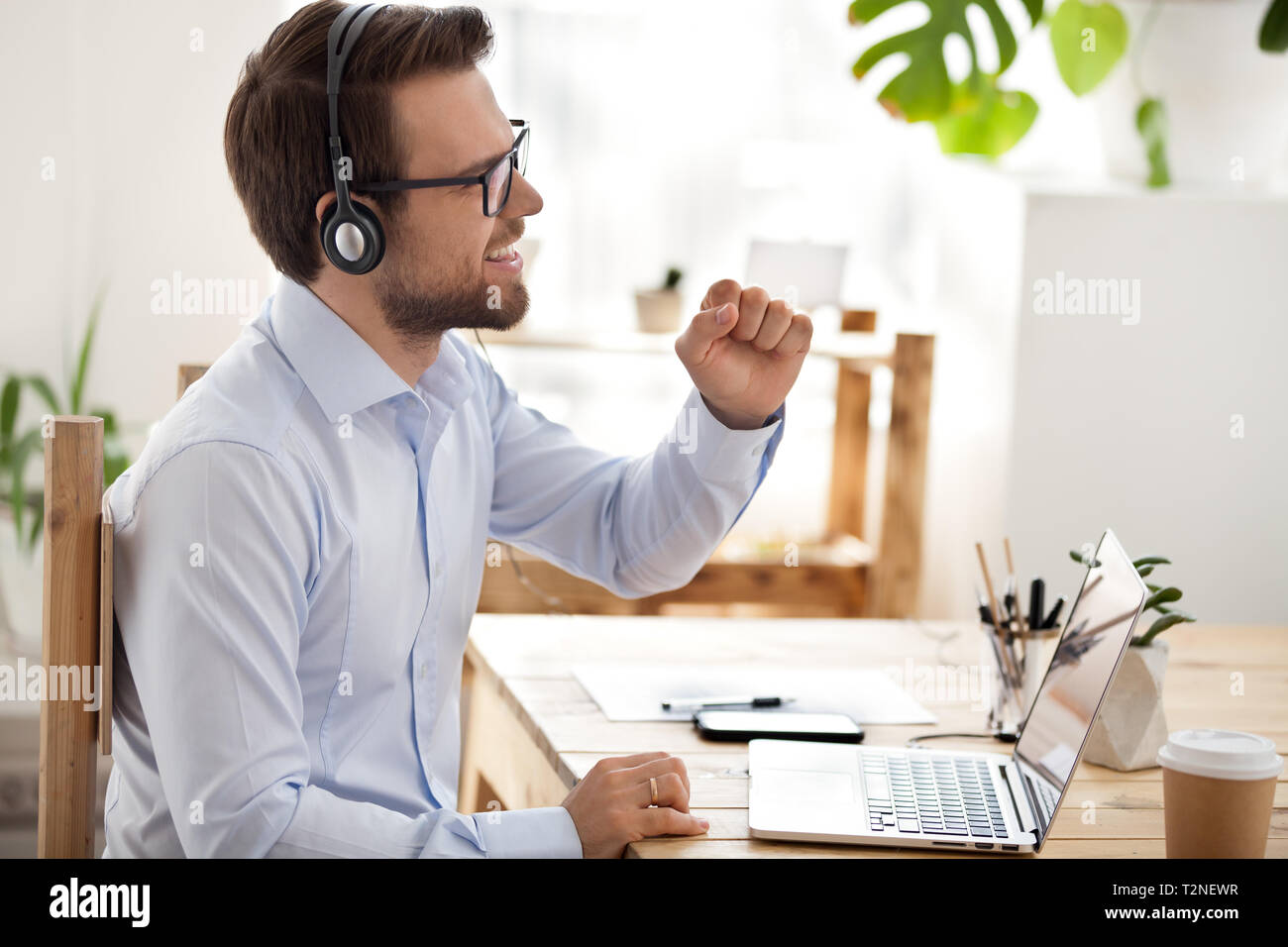 Businessman sitting at the desk in office room take a breath using pc ...