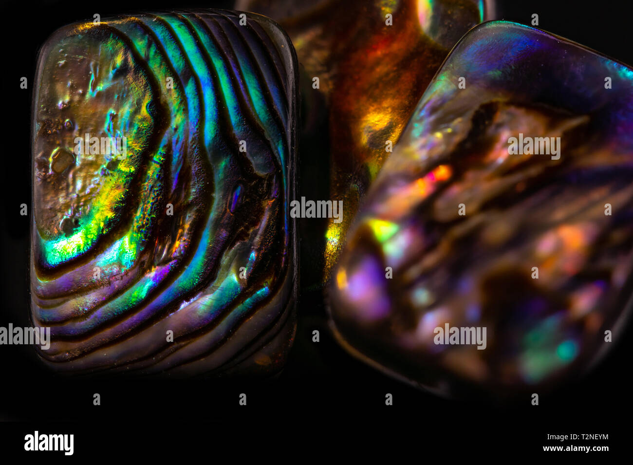 abstract gemstone background, colorful nacre shimmering on black ...