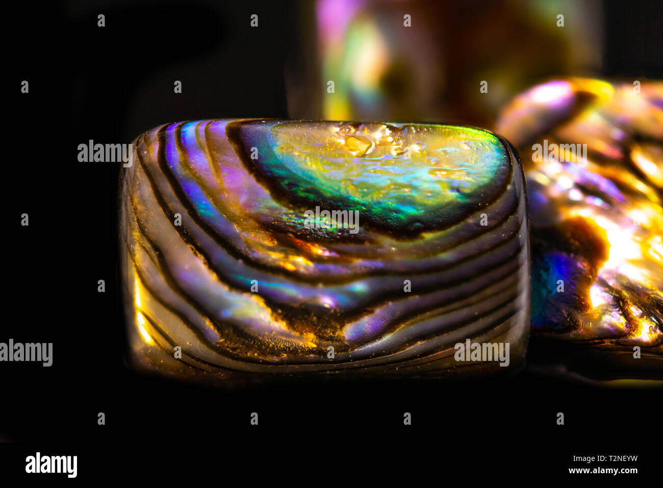 abstract gemstone background, colorful nacre shimmering on black ...