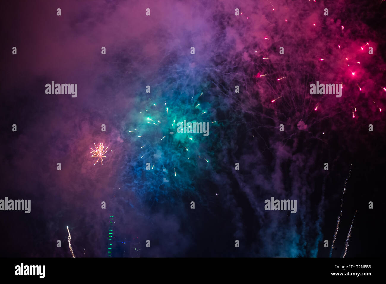 Explosive and colorful holiday fireworks at night sky. Celebration City ...
