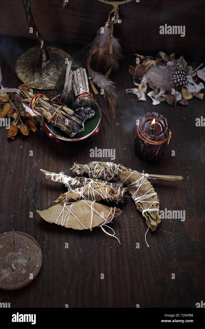 Altar at the fairies. Herbal incense on a dark table. Vertical ...