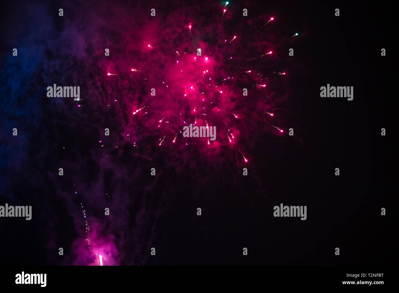 Explosive and colorful holiday fireworks at night sky. Celebration City ...
