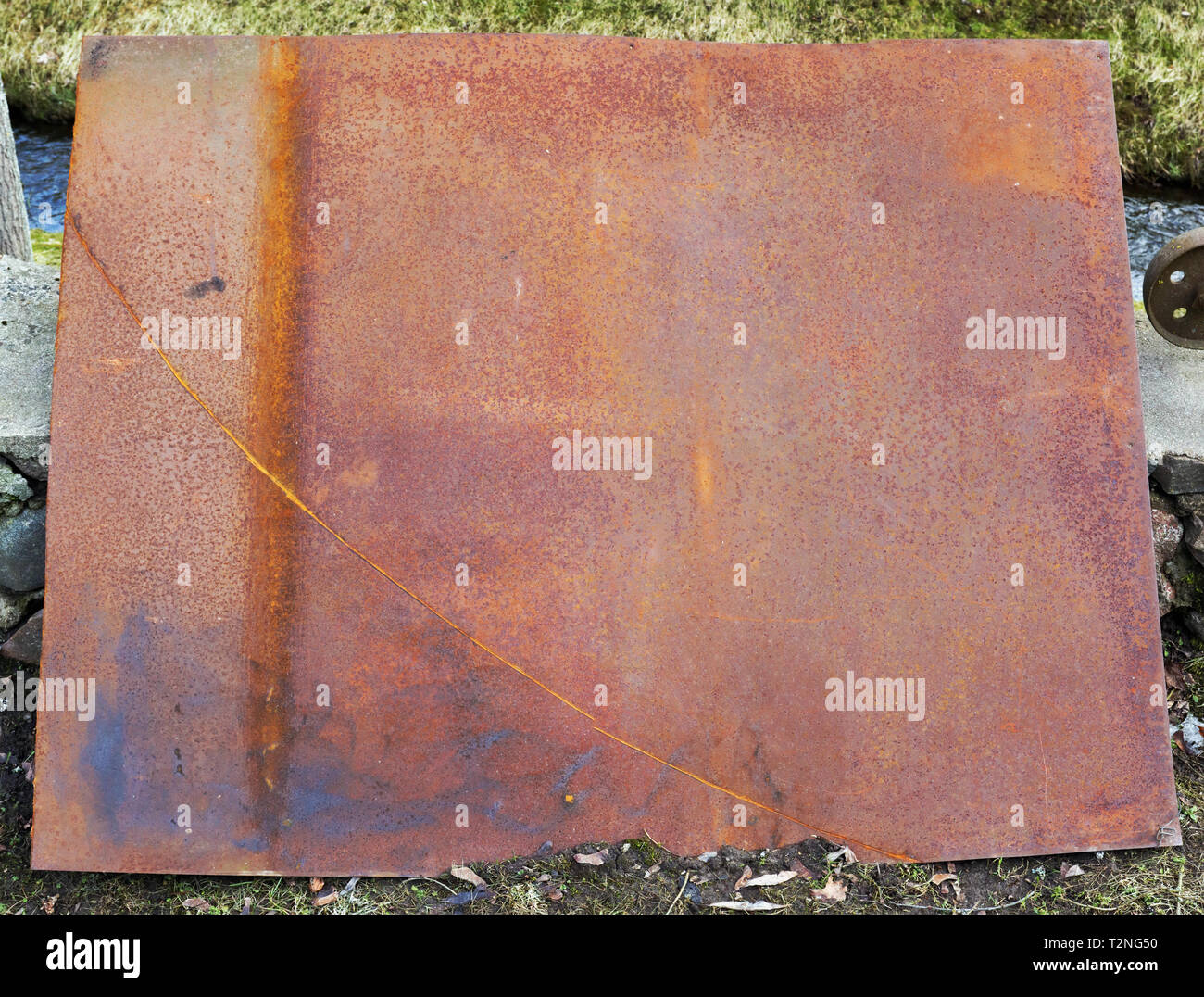 Large rusty iron sheet on a rustic courtyard lie Stock Photo - Alamy