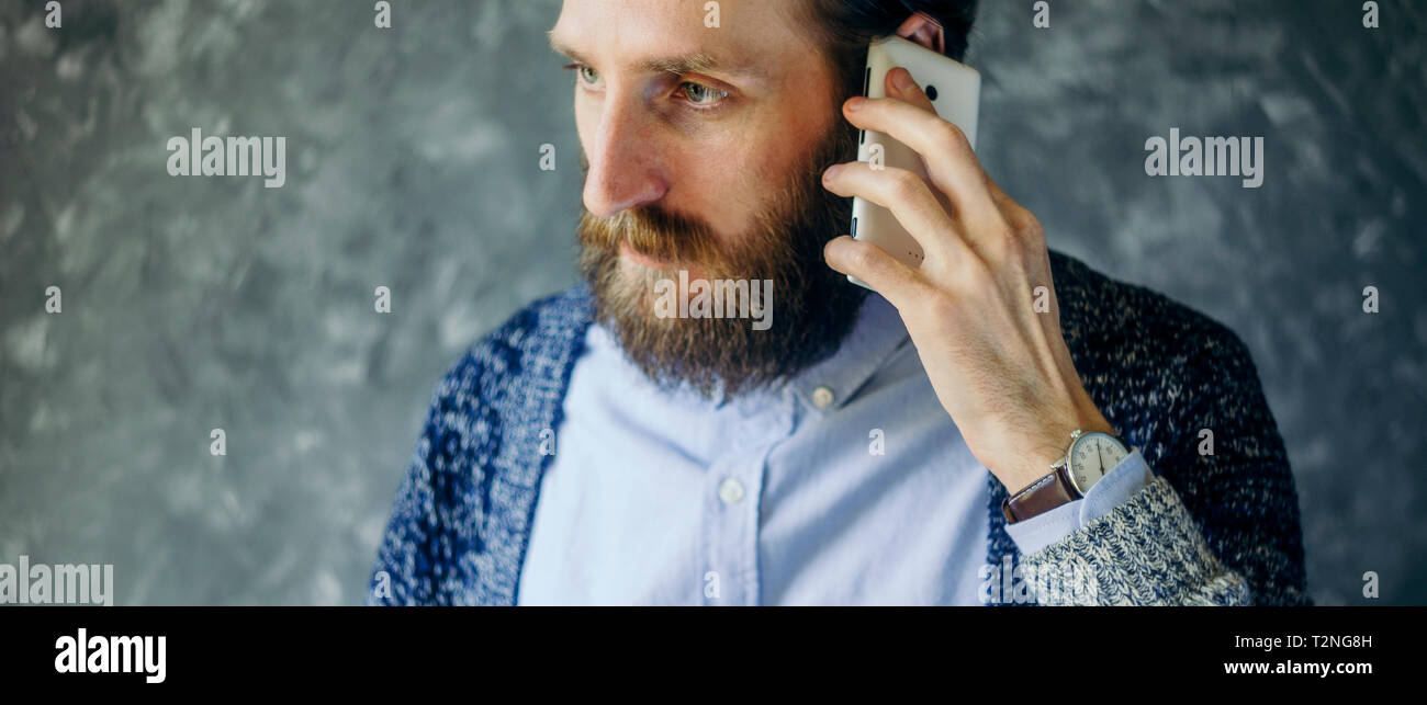 Bearded Man Talking on a Mobile Phone with Indifference. Difficult ...