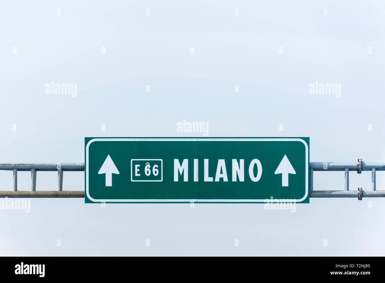 Green highway sign to Milano over light blue sky Stock Photo - Alamy
