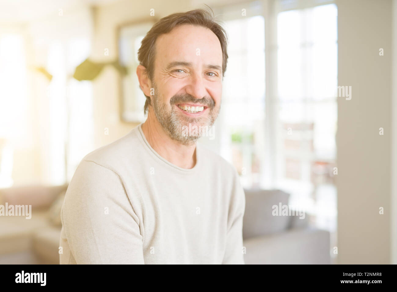 Handsome middle age man smiling looking at the camera at home Stock ...