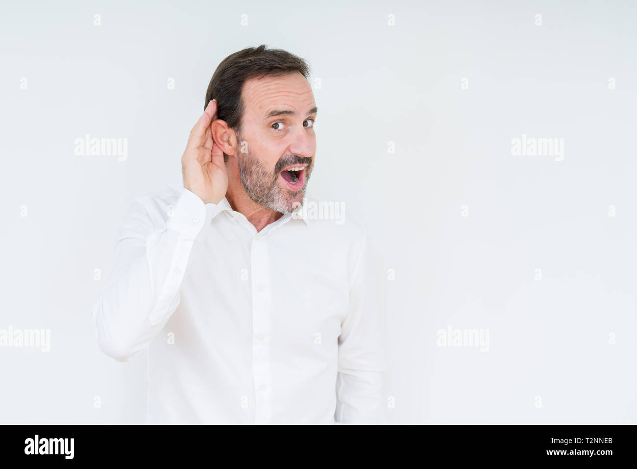 Elegant senior man over isolated background smiling with hand over ear ...