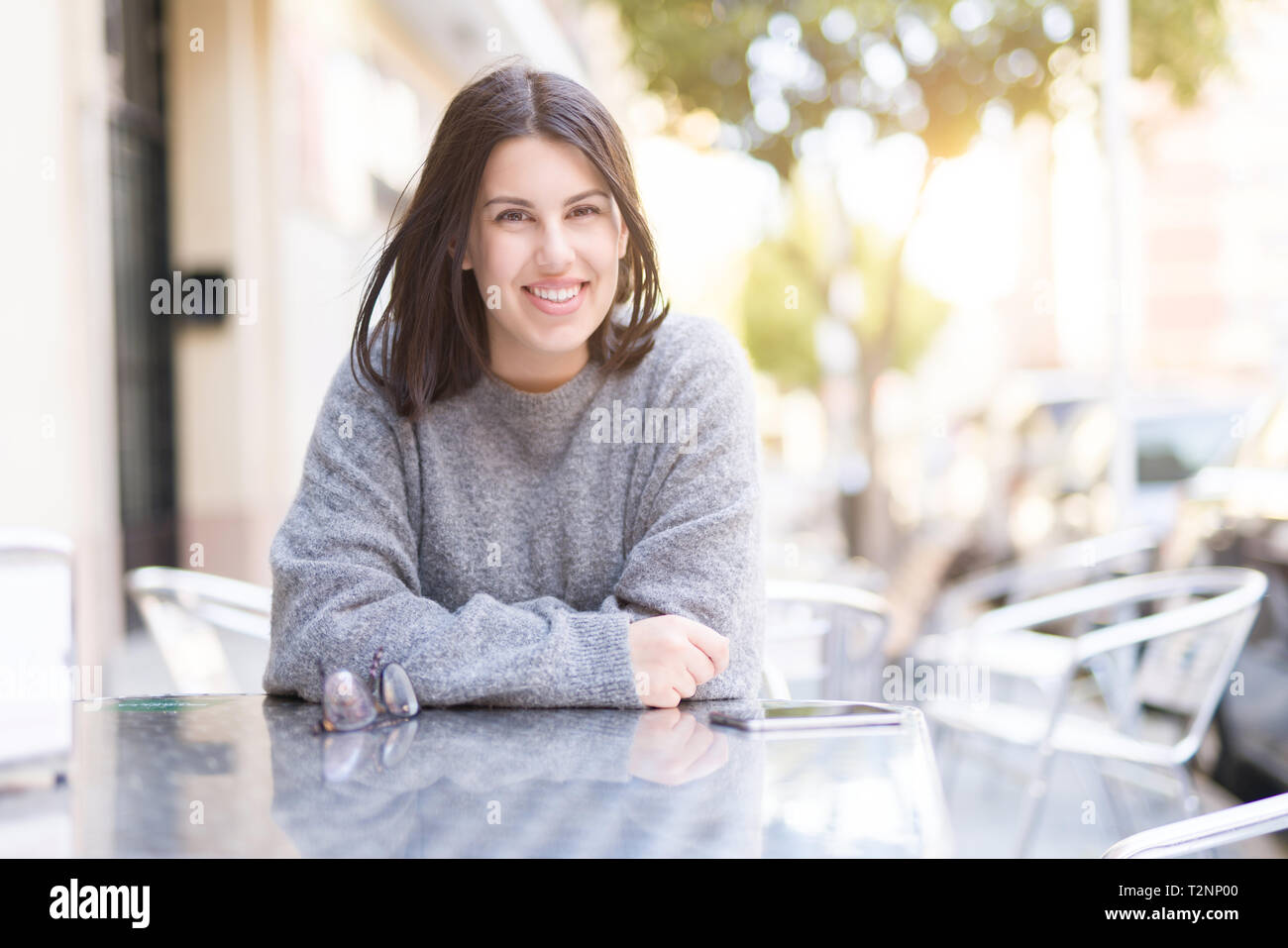 Beautiful young girl smiling cheerful sitting on a cafeteria, relaxing ...