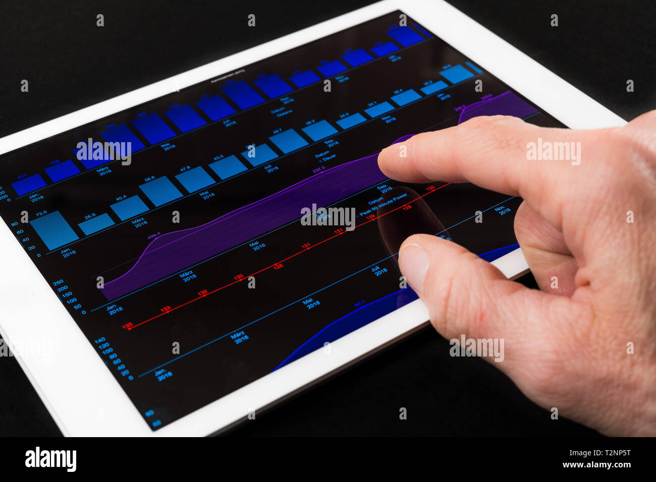 table with tablet computer, graphical diagram Stock Photo - Alamy