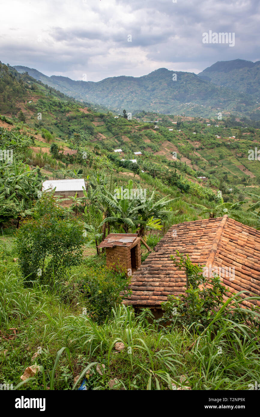 Simple constructed houses and farmland terraced along the countryside ...