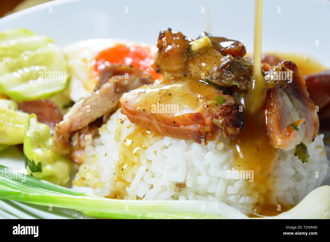 barbecue red pork on rice dressing sweet sauce Stock Photo - Alamy