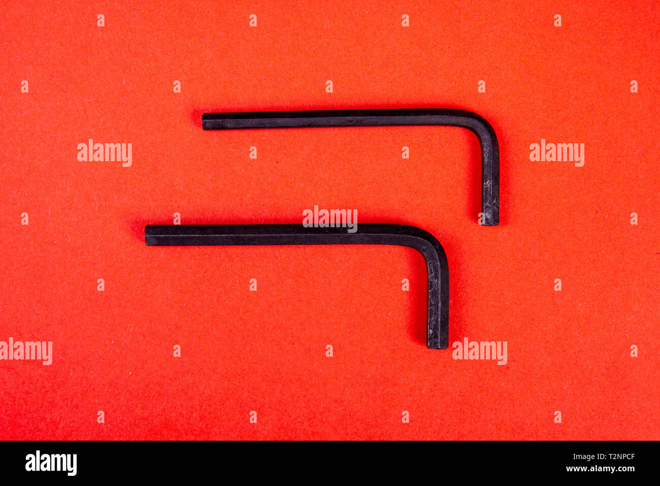 two Allen keys on red background Stock Photo - Alamy