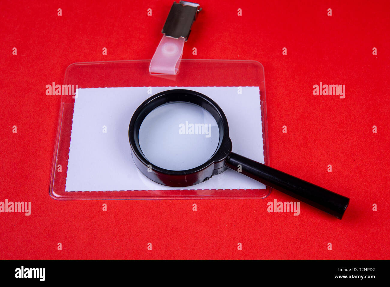 Magnifier with name card to clip on Stock Photo - Alamy