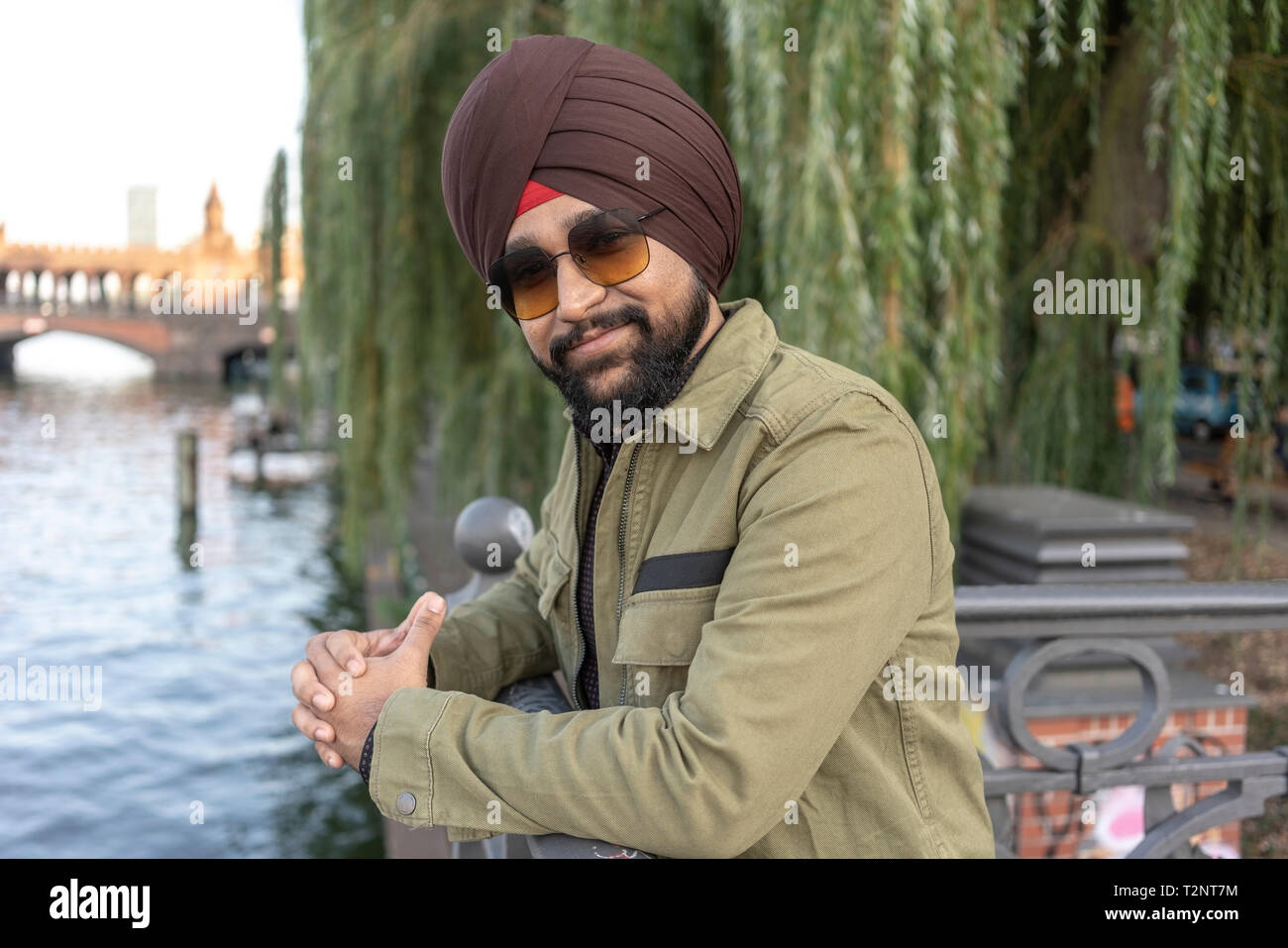 Indian man exploring city, river in background, Berlin, Germany Stock ...