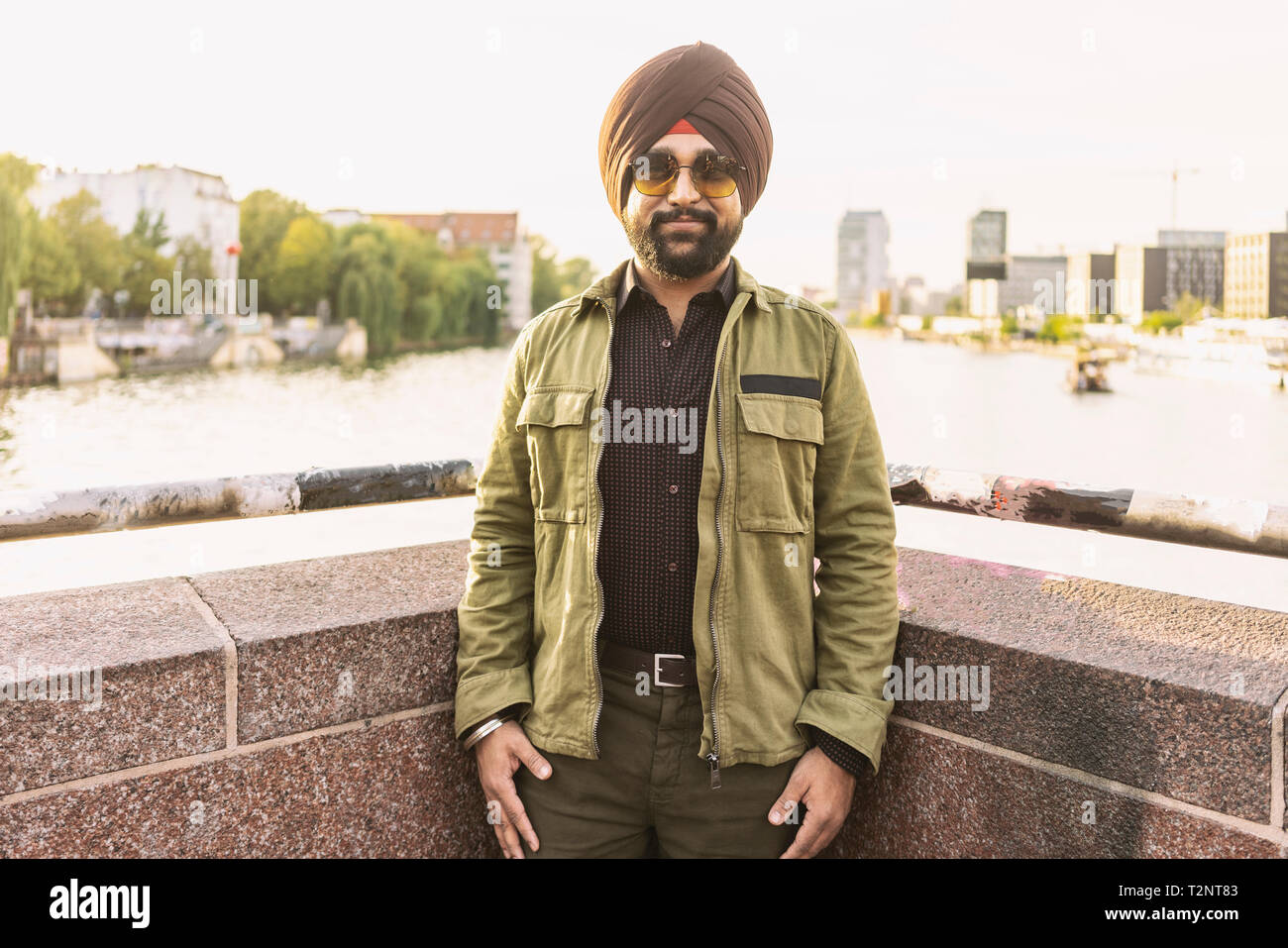 Indian man exploring city, river in background, Berlin, Germany Stock ...