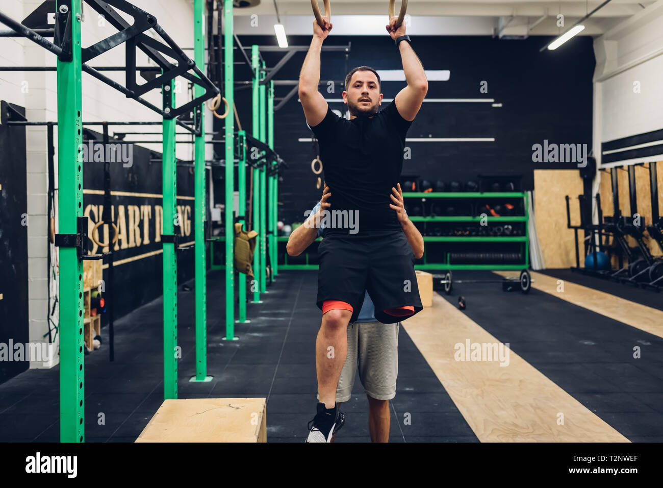 Personal trainer working with man with disability in gym Stock Photo ...
