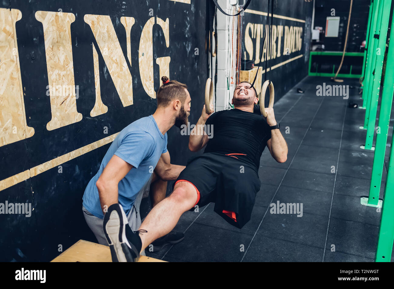Personal trainer working with man with disability in gym Stock Photo ...