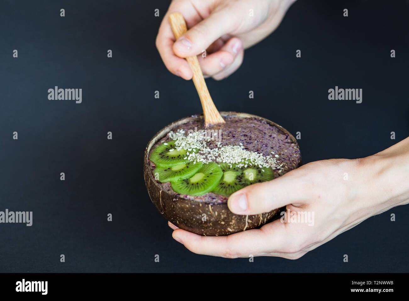 Healthy smoothie with fruits, plate made from coconut shell and wood ...